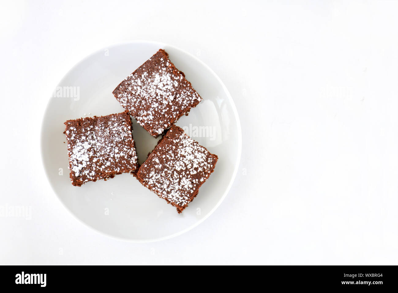 Homemade chocolate brownies squares on white background in horizontal ...