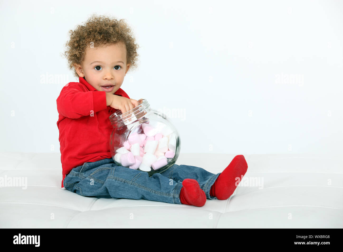 Baby eating sweets Stock Photo - Alamy