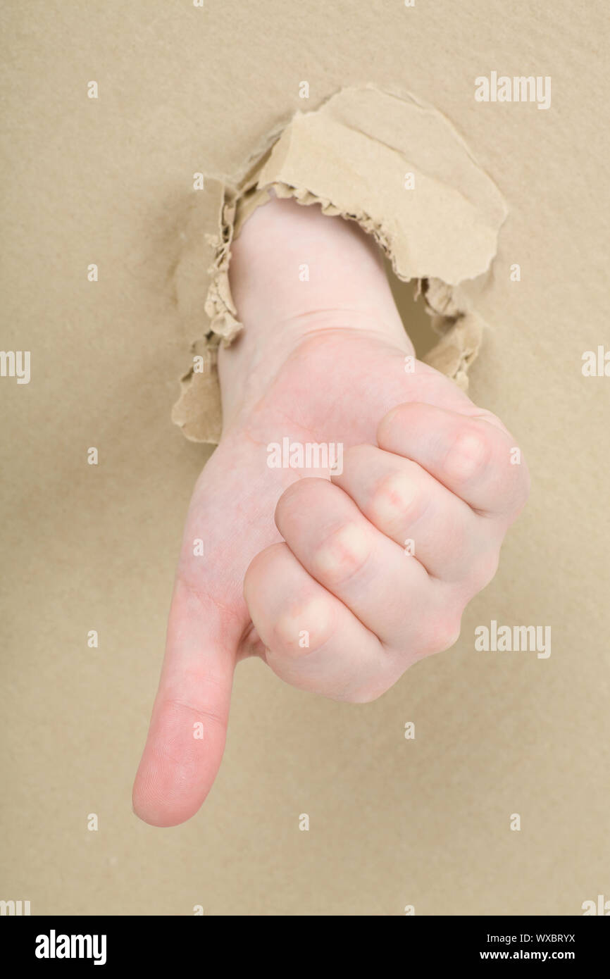 Gesture male hand through from hole in cardboard Stock Photo - Alamy