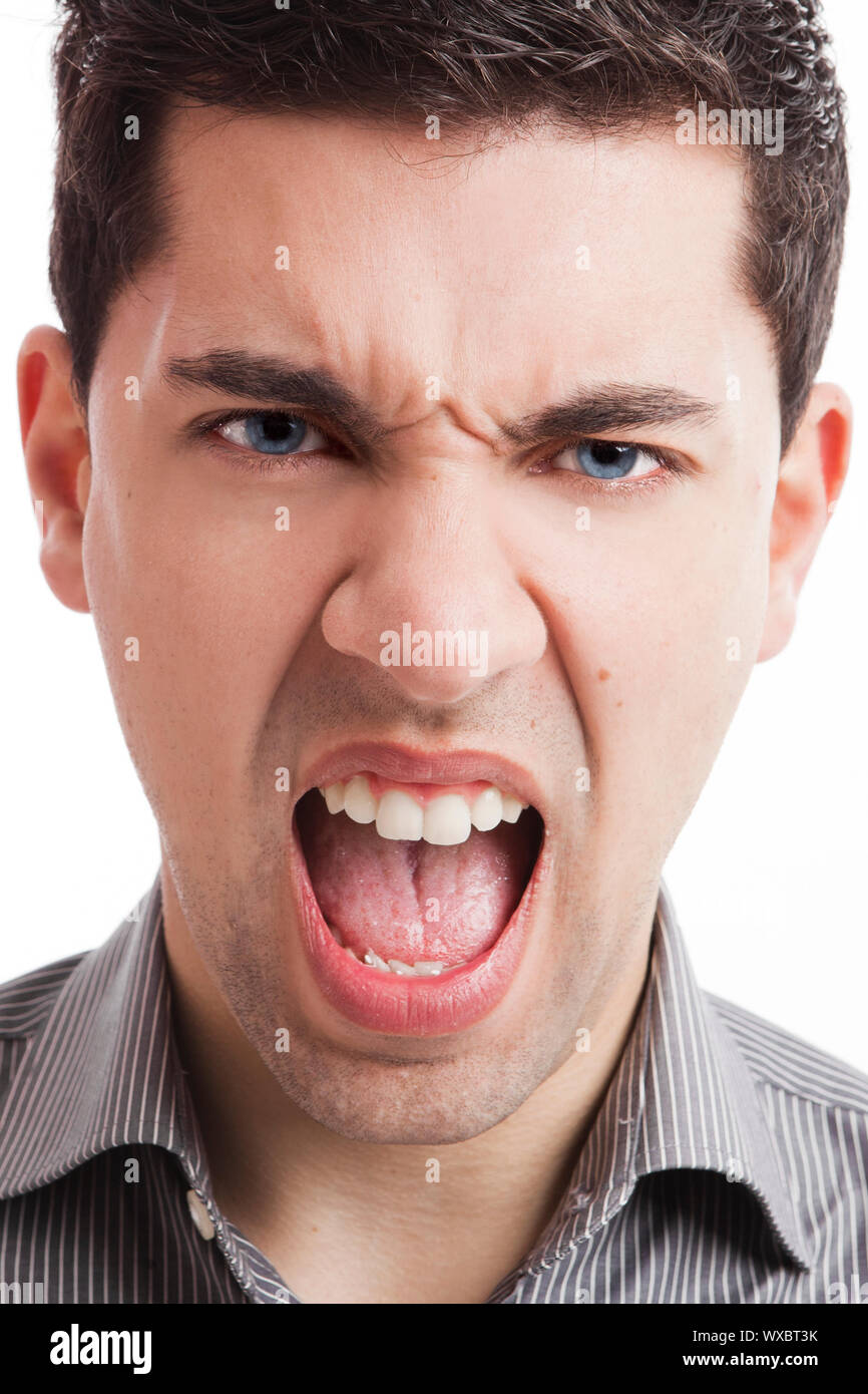 Portrait of a angry young man yelling, isolated on white background ...