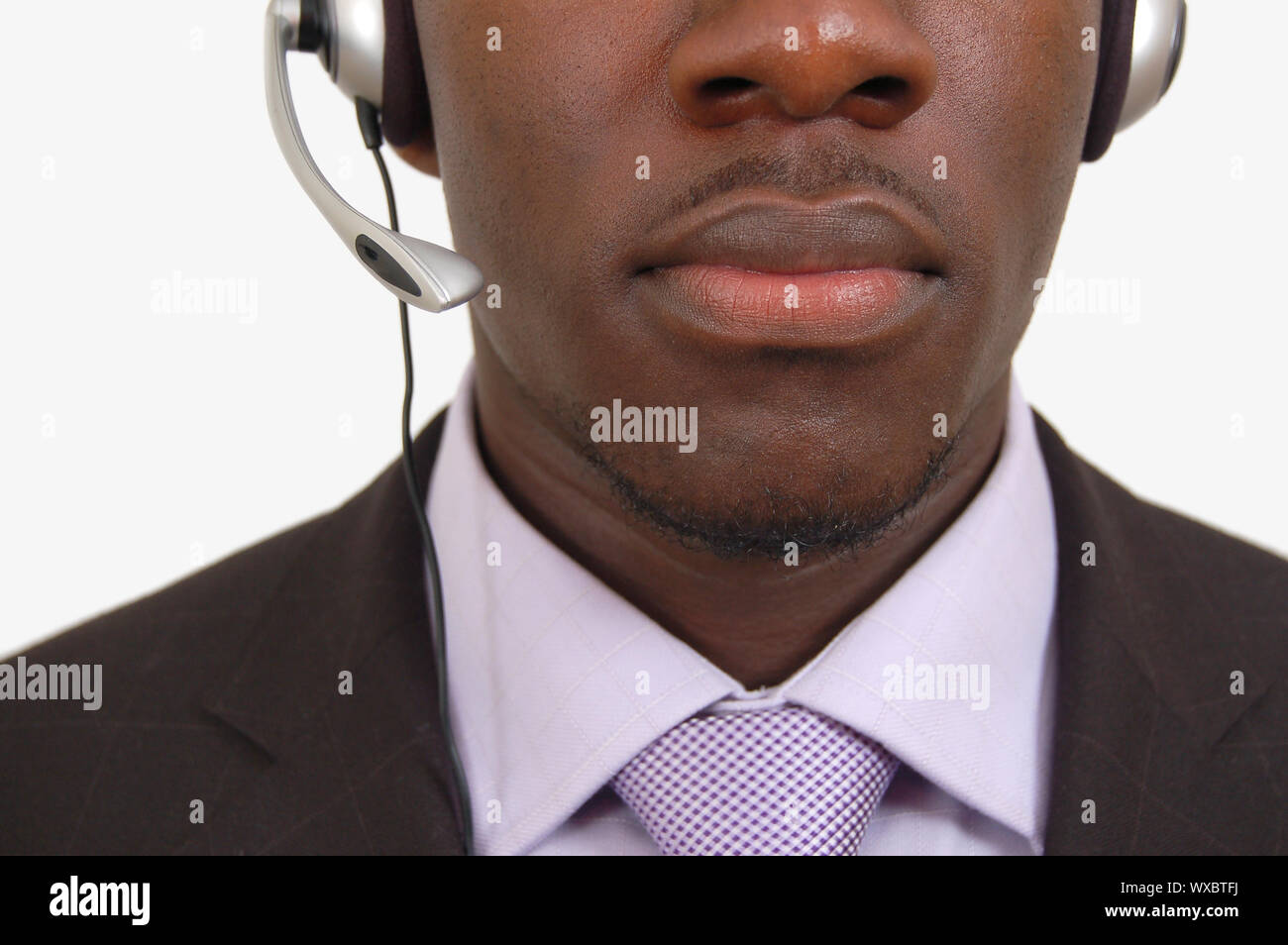 This is an image of close up of a man with a microphone headset on ...