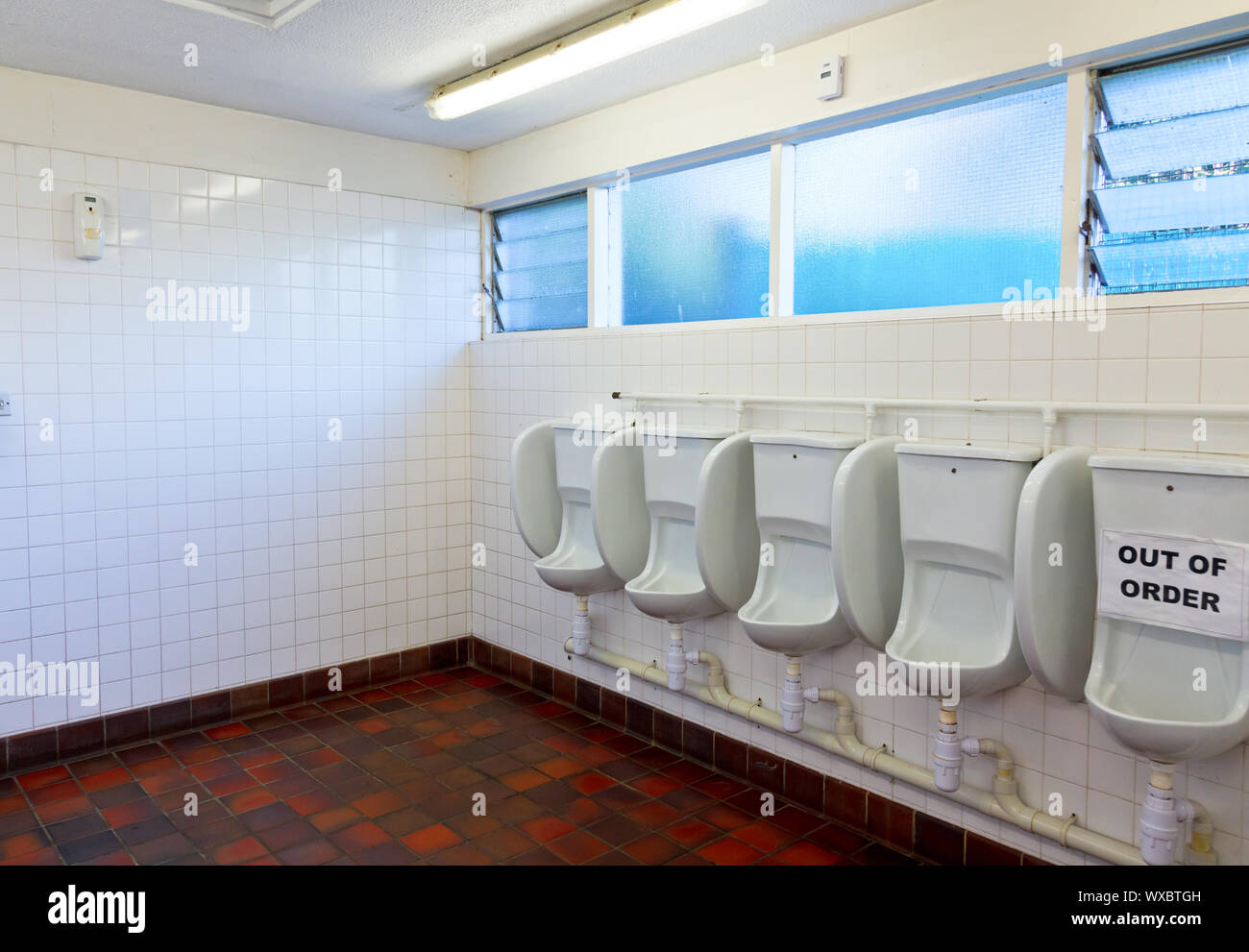 Empty public lavatory with urinal out of order Stock Photo - Alamy