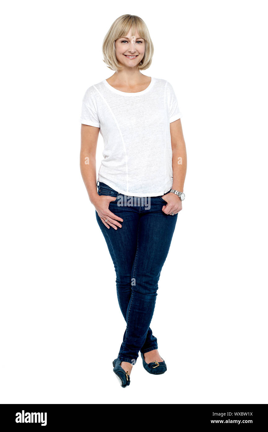 Fashionable middle aged woman posing in style, legs crossed Stock Photo ...