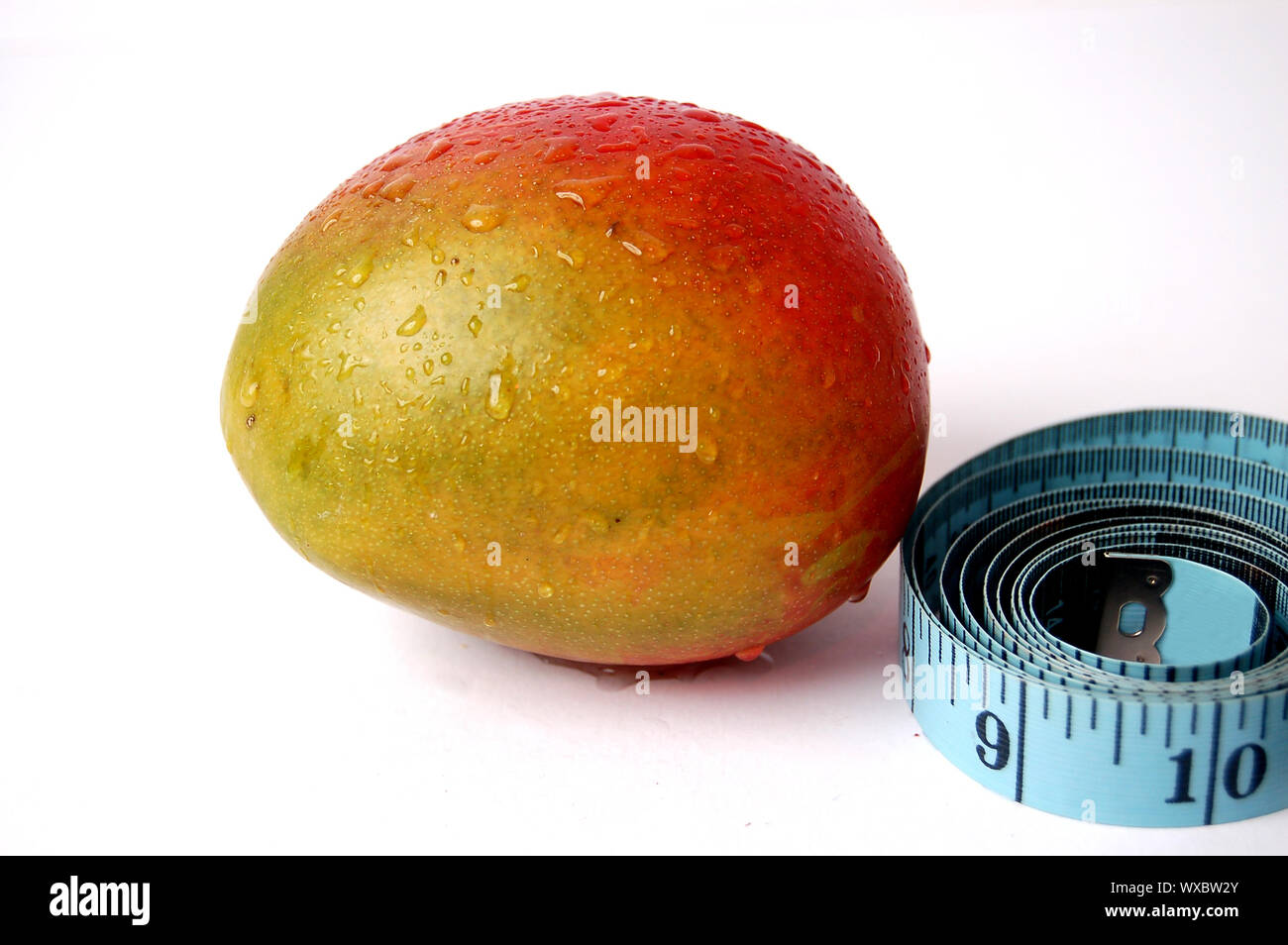 This is an image of a mango with a measuring tape Stock Photo - Alamy