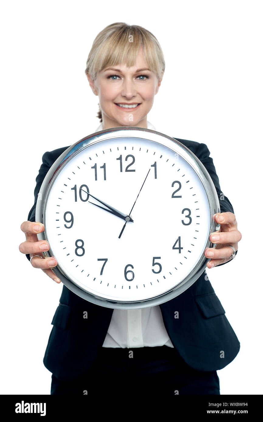 Business executive displaying big wall clock which strikes 9:50 Stock ...