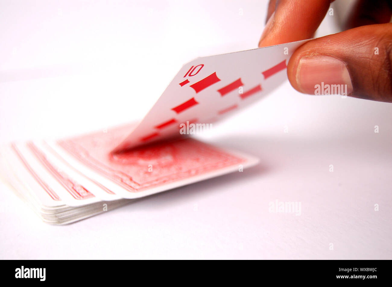 This is an image of a black hand picking up, the winning 10 diamond ...