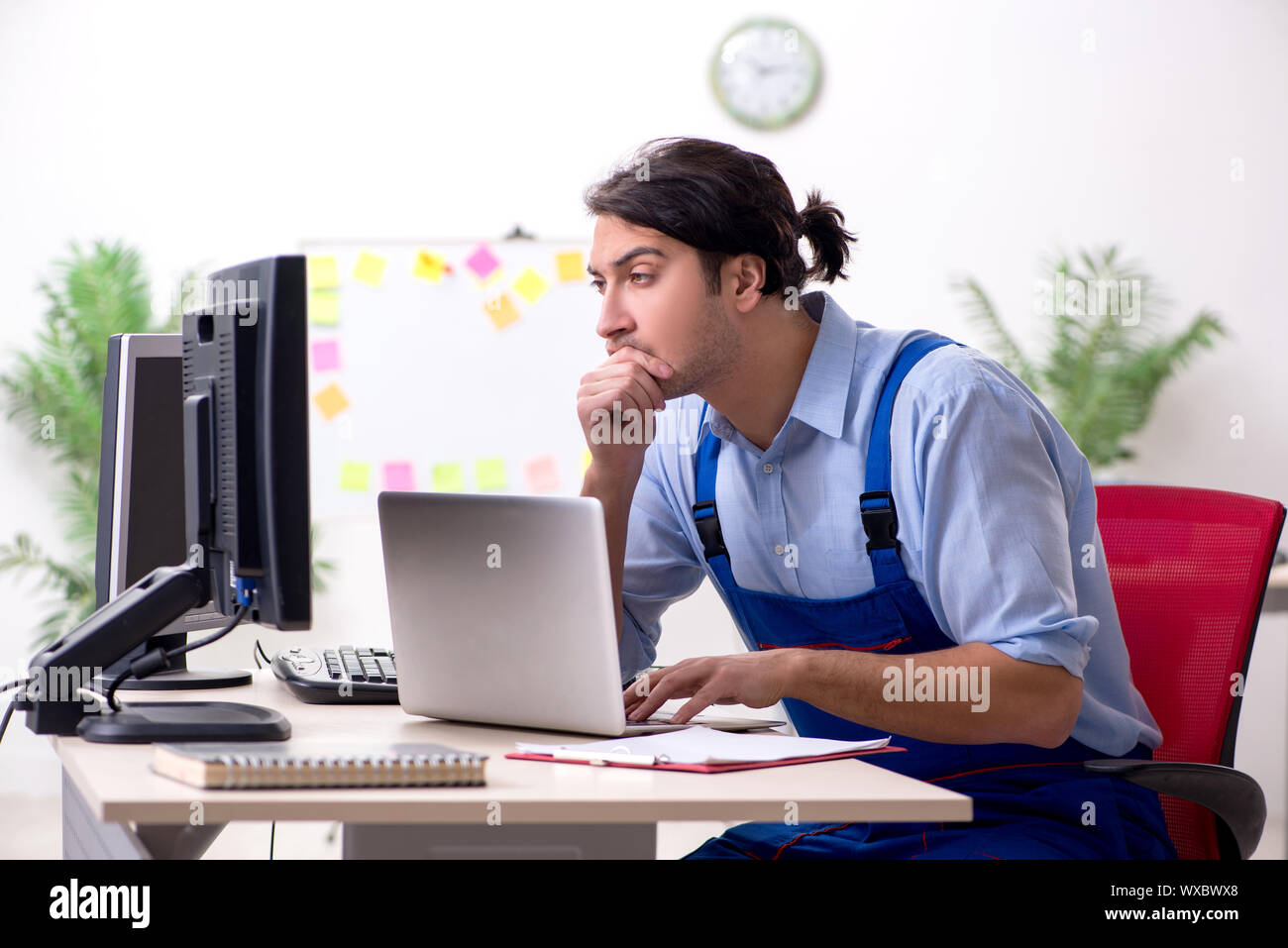 Male it specialist working in the office Stock Photo - Alamy