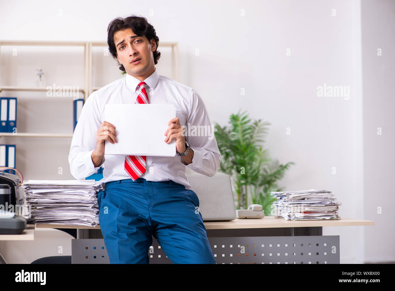 Young employee making copies at copying machine Stock Photo - Alamy