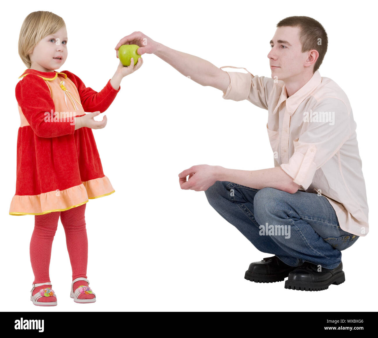 Man give green apple to the girl on white Stock Photo - Alamy