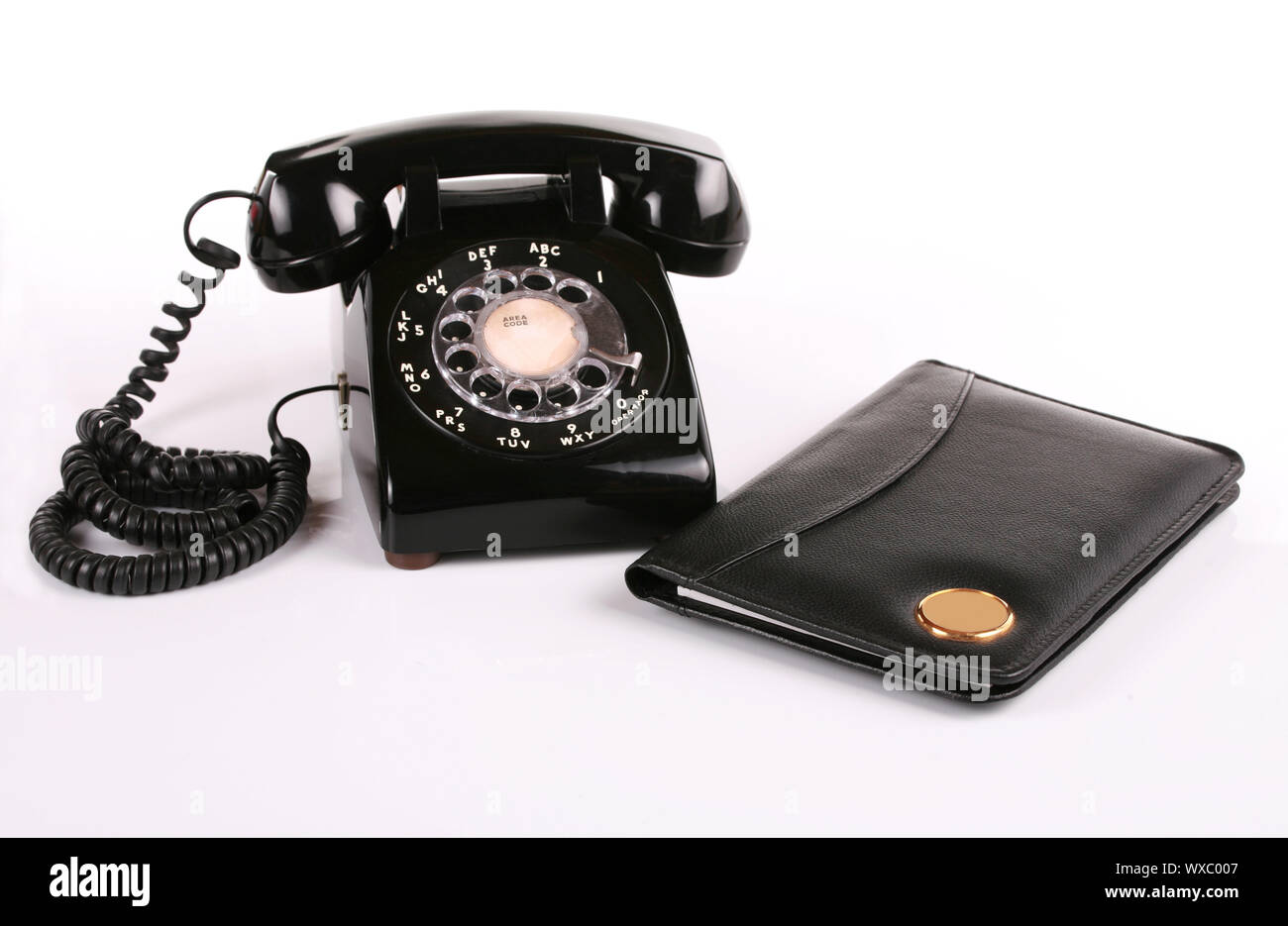 Old fashioned black rotary phone and notepad Stock Photo - Alamy