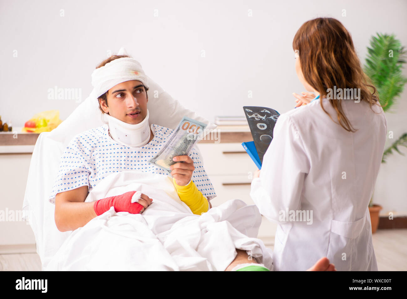 Young doctor examining injured patient Stock Photo - Alamy