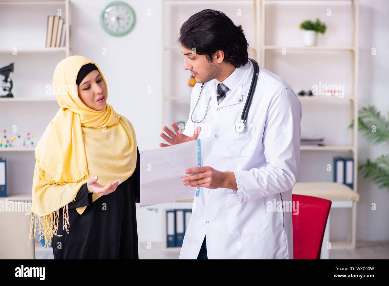 Female arab patient visiting male doctor Stock Photo - Alamy