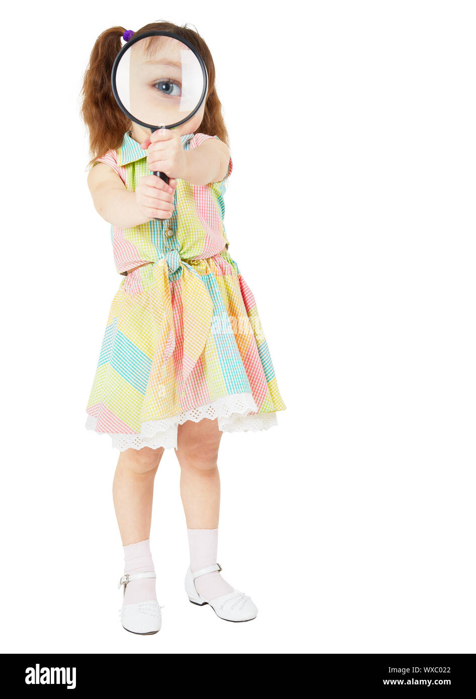Comical child with a large magnifying glass in hands Stock Photo - Alamy