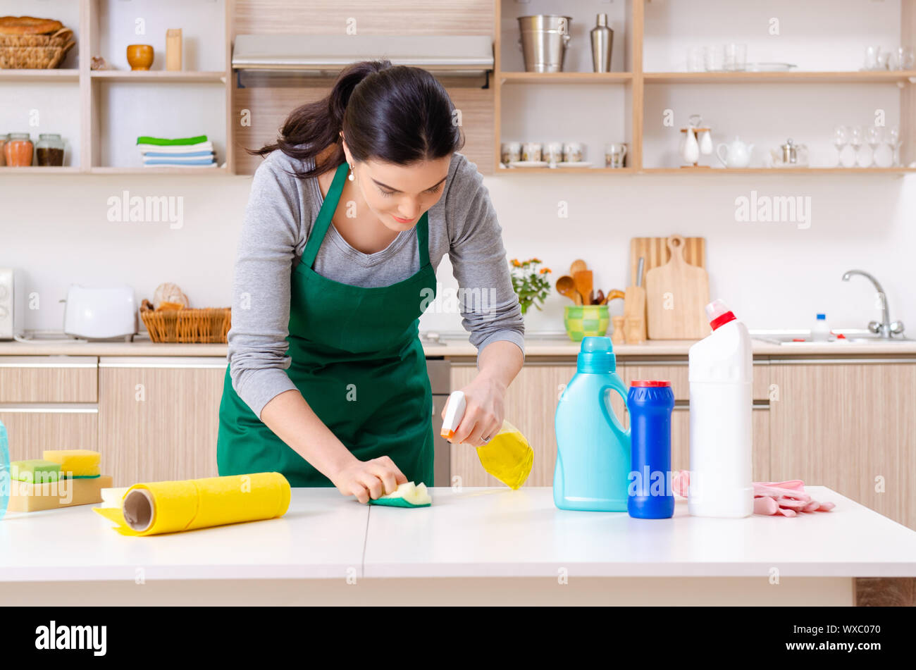 Young female contractor doing housework Stock Photo - Alamy