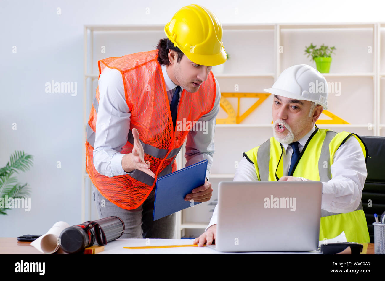 Two engineers colleagues working under project Stock Photo - Alamy