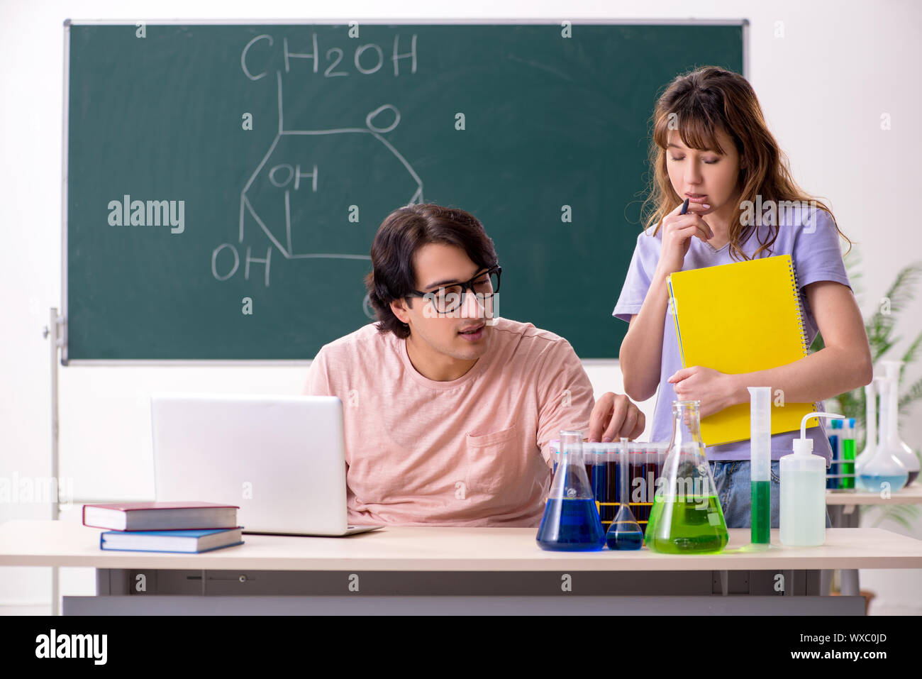 Two chemists students in classroom Stock Photo - Alamy