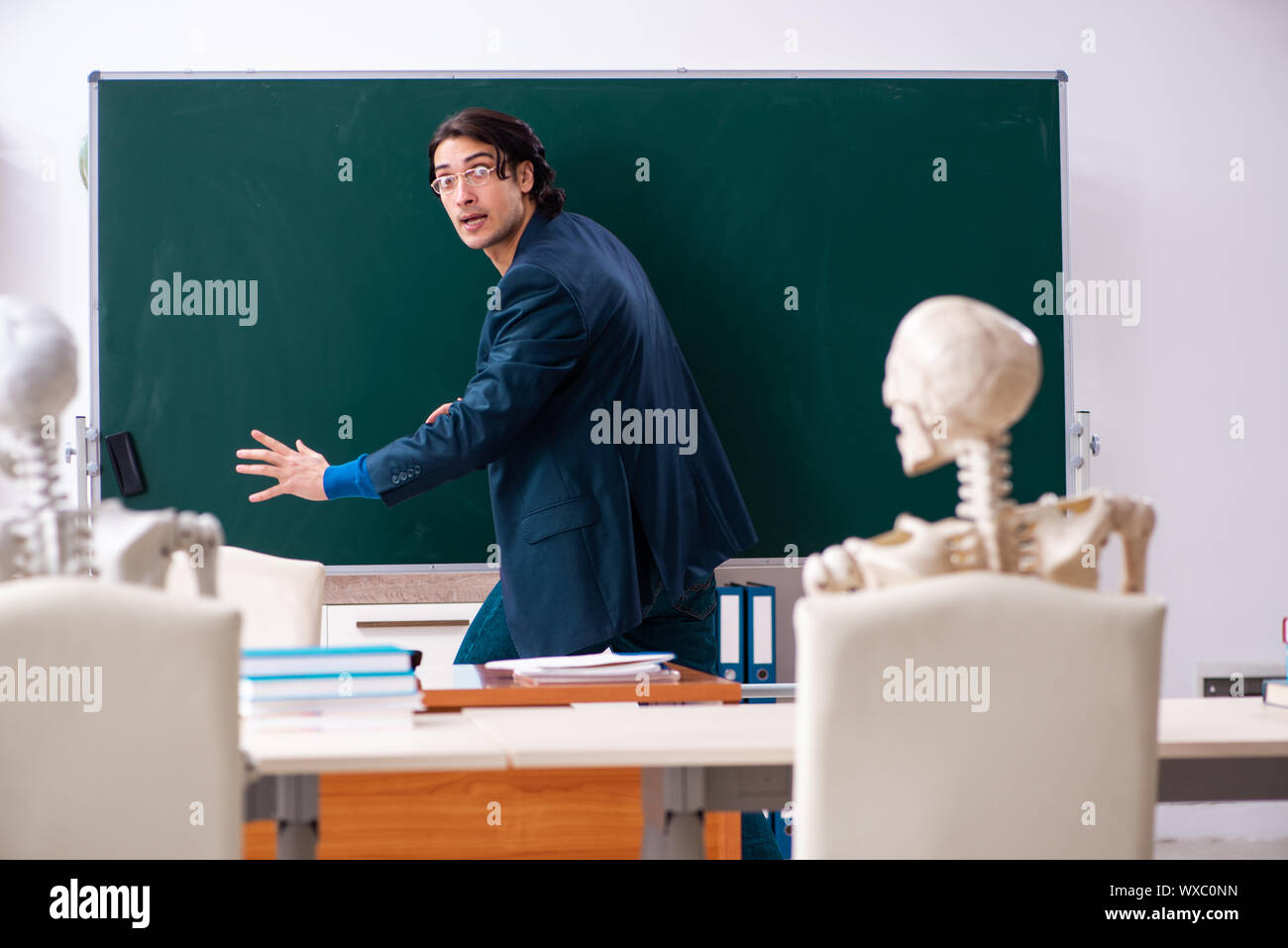 Male teacher and skeleton student in the classroom Stock Photo - Alamy