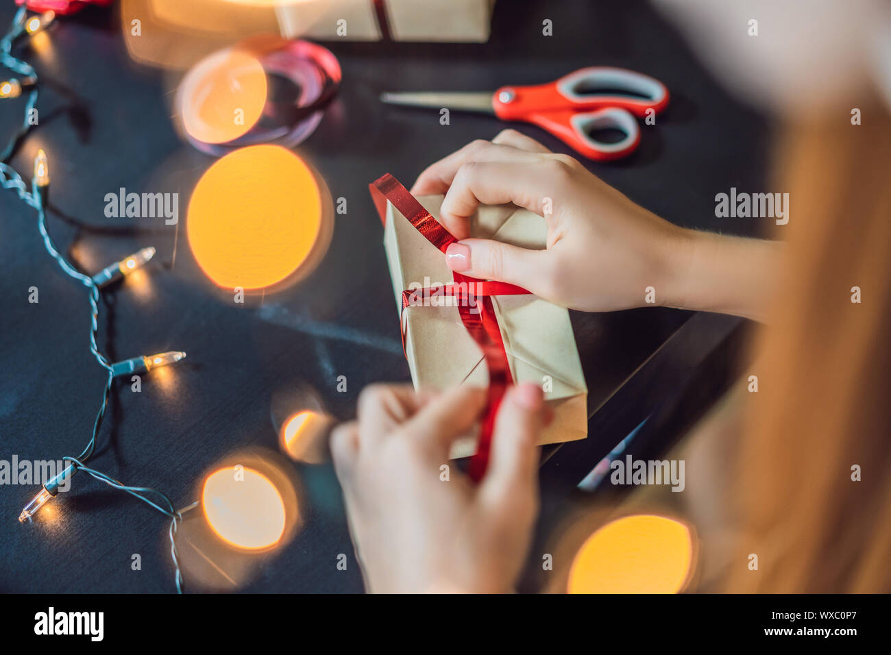 Woman wrapping present roll tape hi-res stock photography and images ...