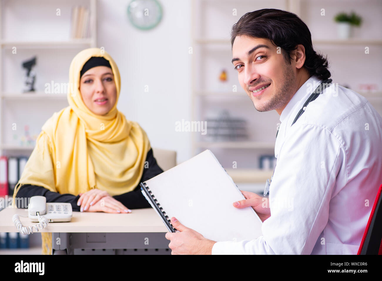 Female arab patient visiting male doctor Stock Photo - Alamy