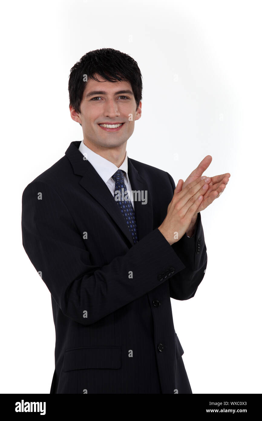 Smiling businessman clapping his hands Stock Photo - Alamy