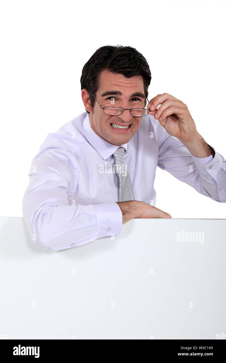 Doubtful man peering over his glasses Stock Photo - Alamy