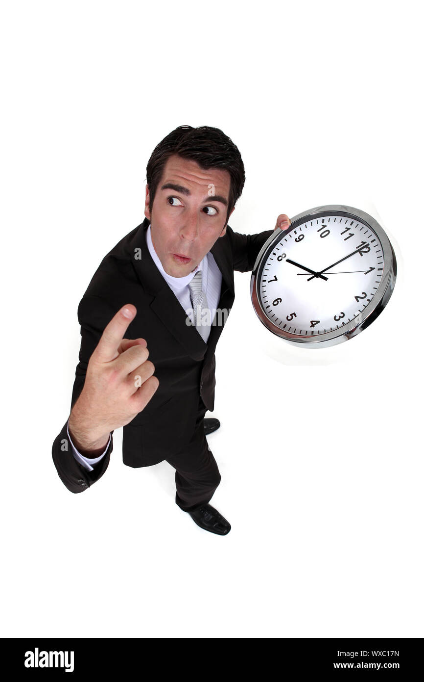 man holding clock isolated on white Stock Photo - Alamy