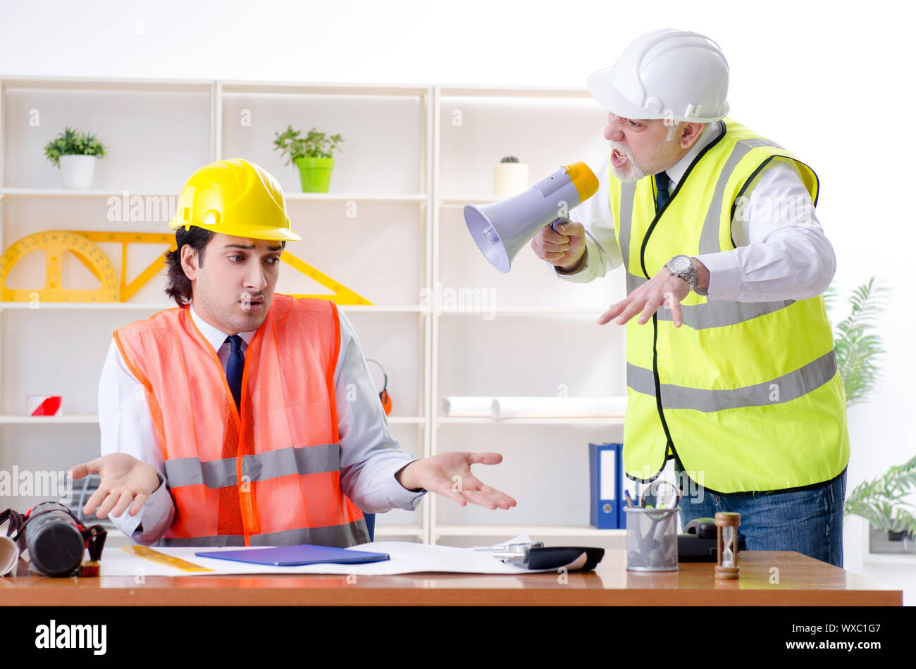 Two engineers colleagues working under project Stock Photo - Alamy