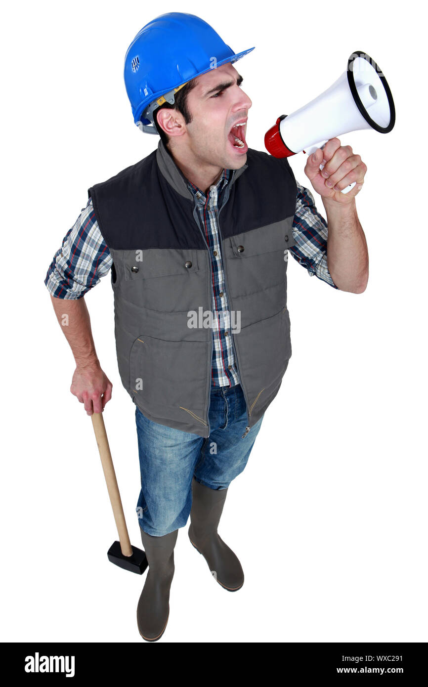 Construction worker with a loudspeaker Stock Photo - Alamy