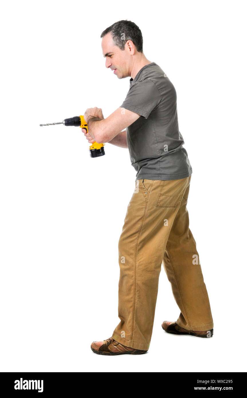 Strong handyman pushing on his cordless drill Stock Photo - Alamy