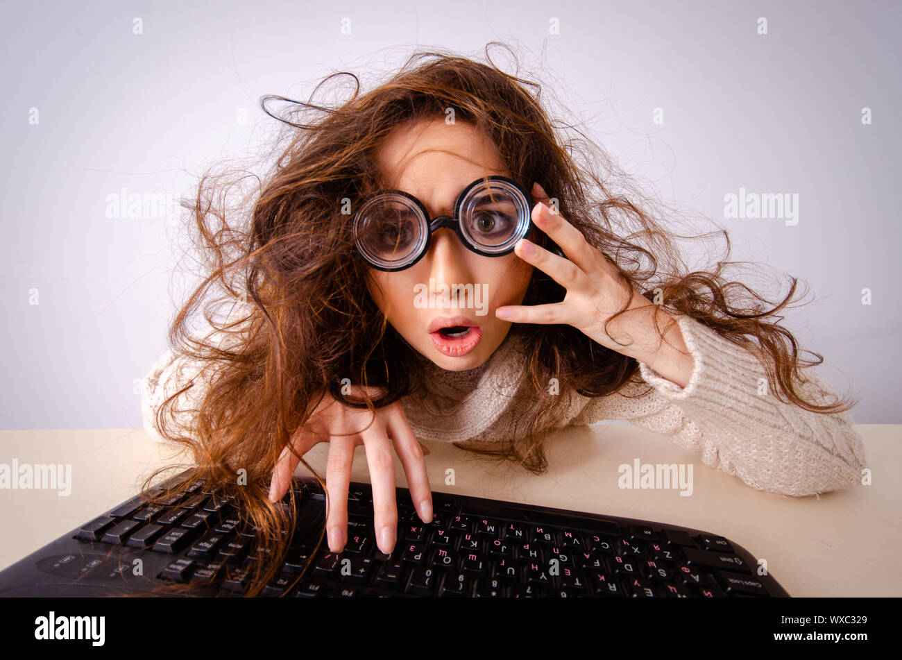 Funny nerd girl working on computer Stock Photo - Alamy