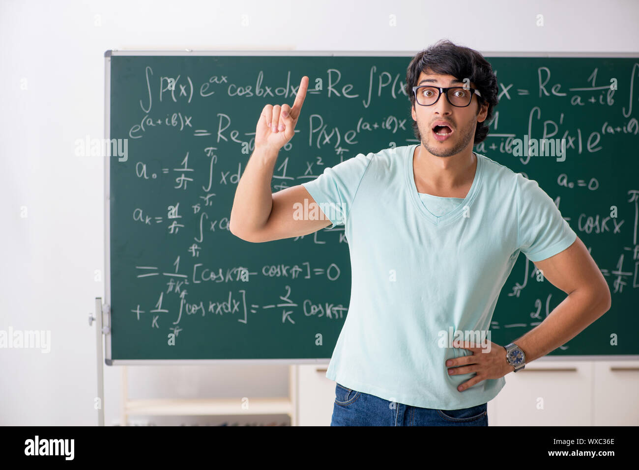 Young male student mathematician in front of chalkboard Stock Photo - Alamy