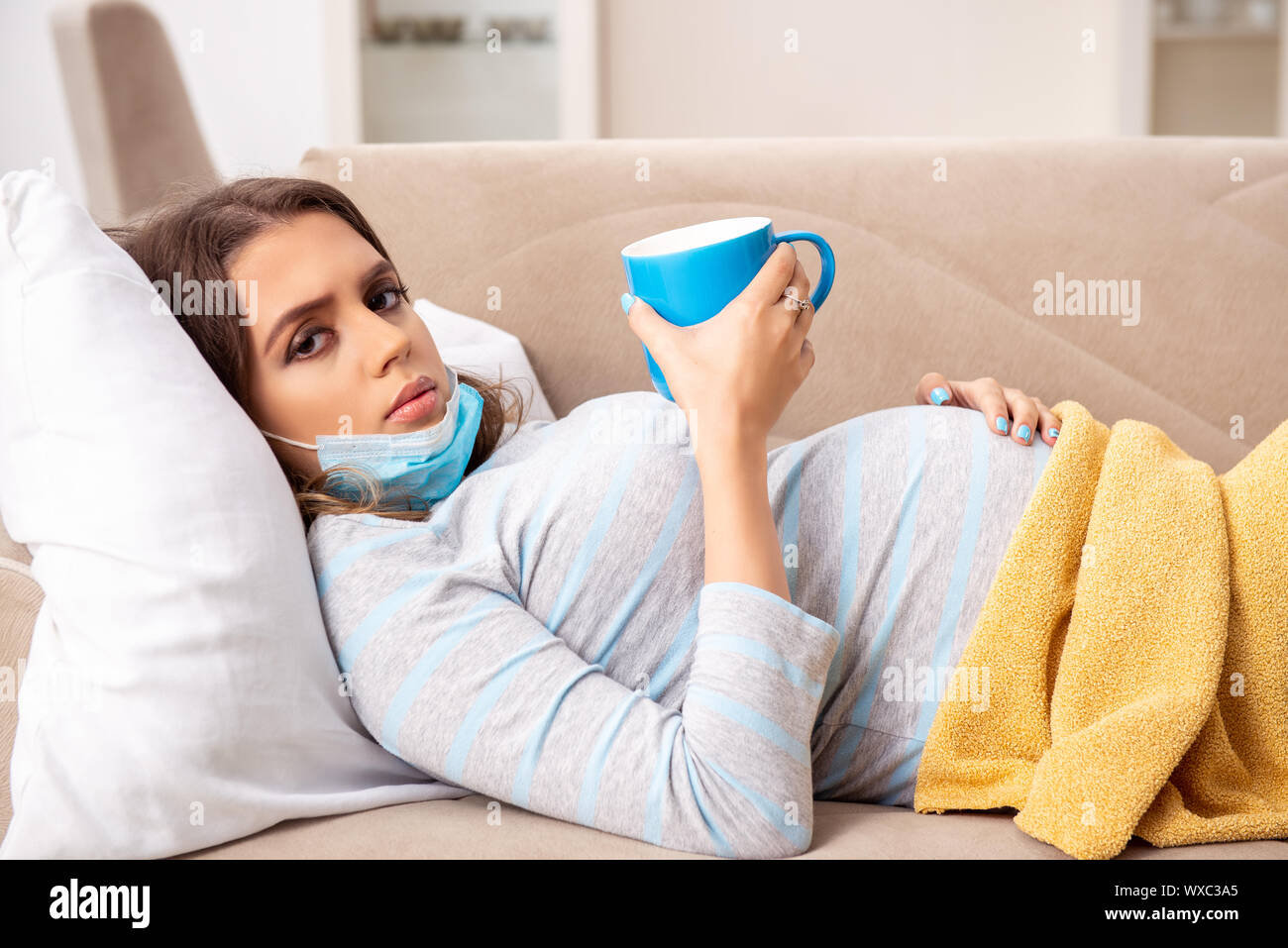 Sick pregnant woman suffering at home Stock Photo - Alamy