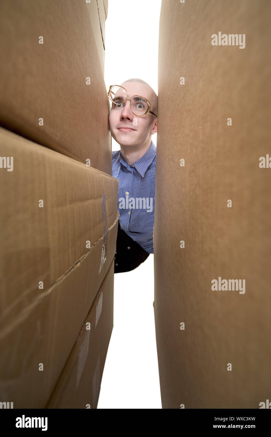 Male face between cardboard boxes on white Stock Photo - Alamy