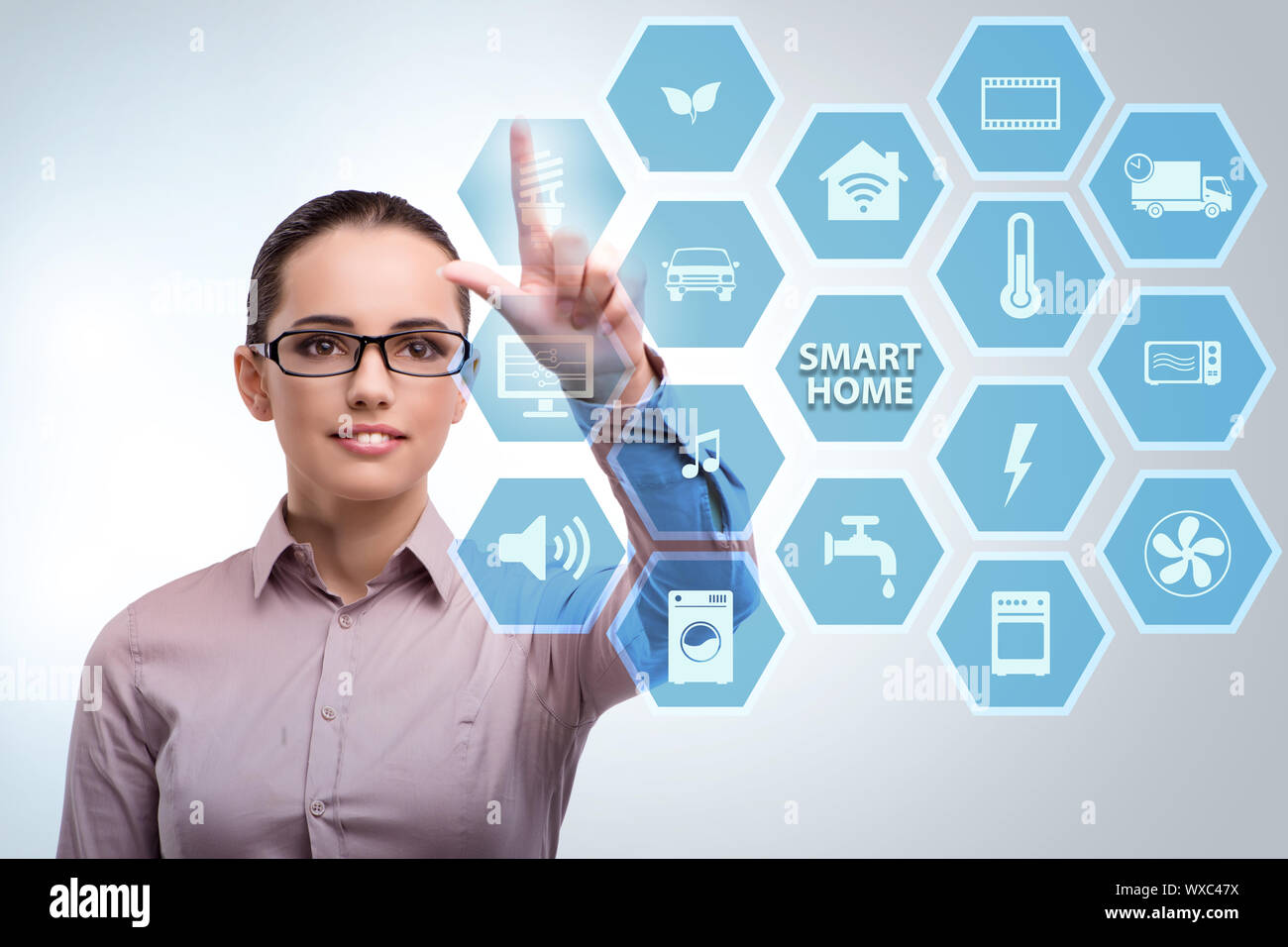 Smart home concept with woman Stock Photo - Alamy