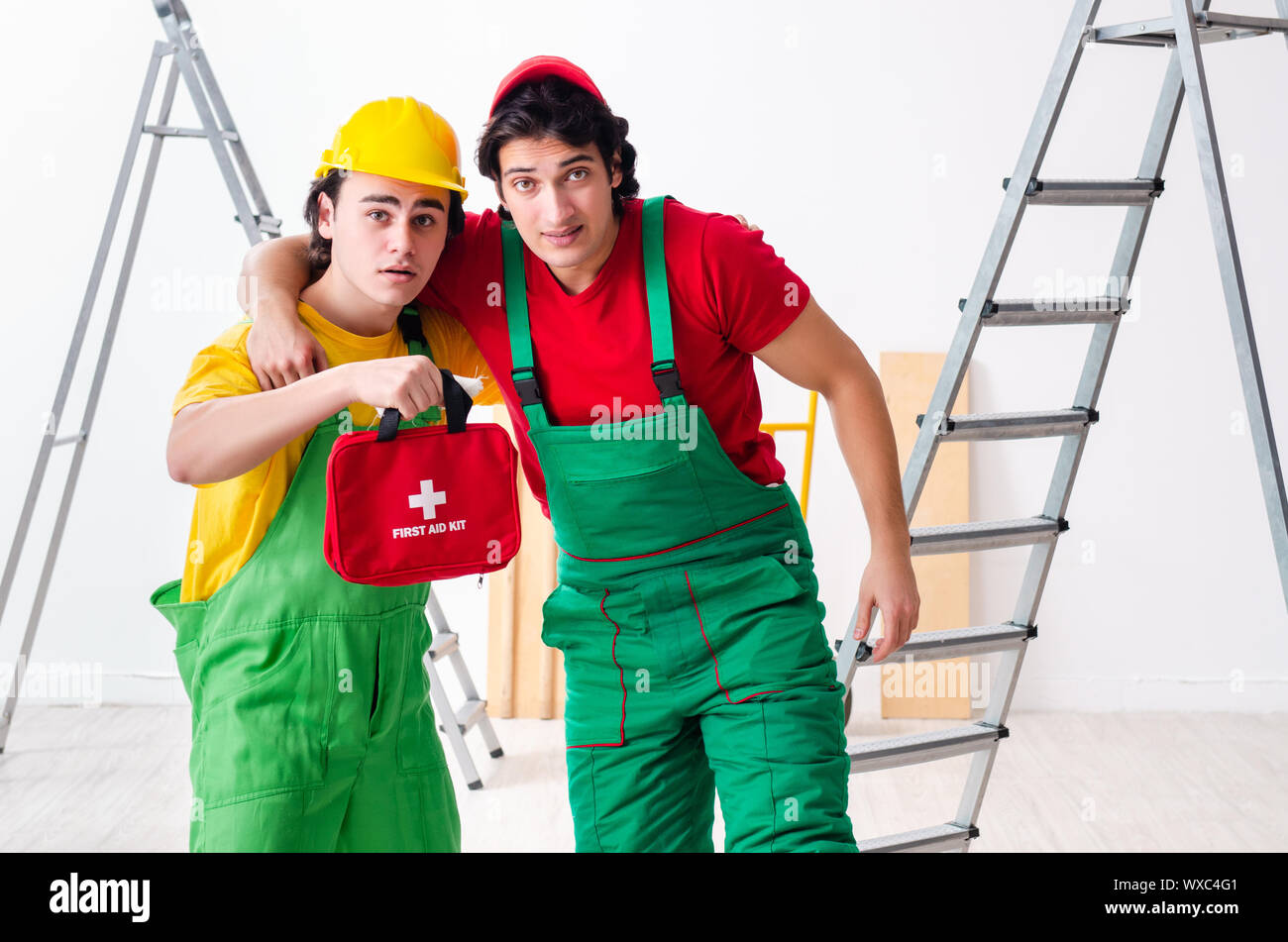 Injured worker and his workmate Stock Photo - Alamy