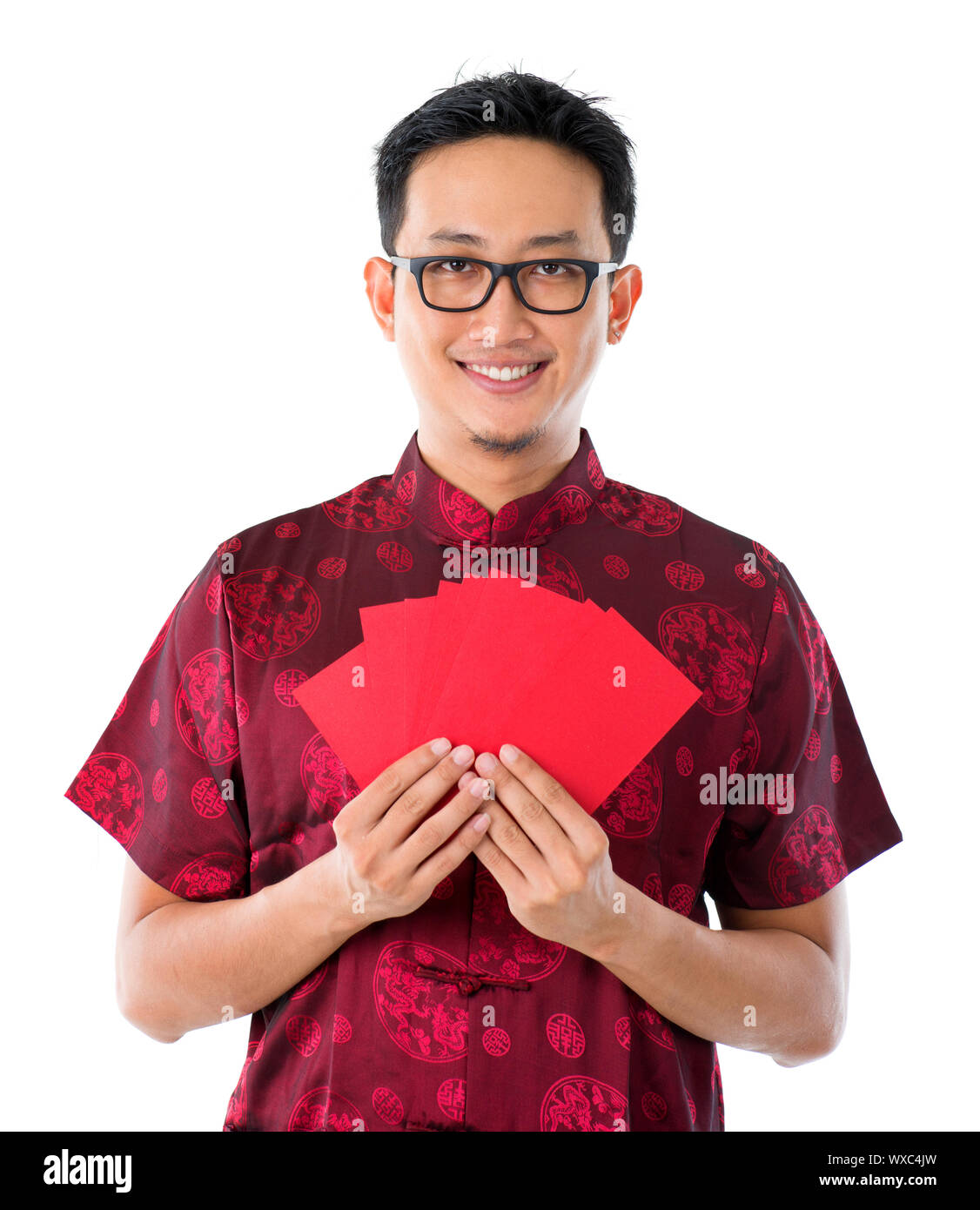 Southeast Asian male in cheongsam hands holding red packets / ang pow ...