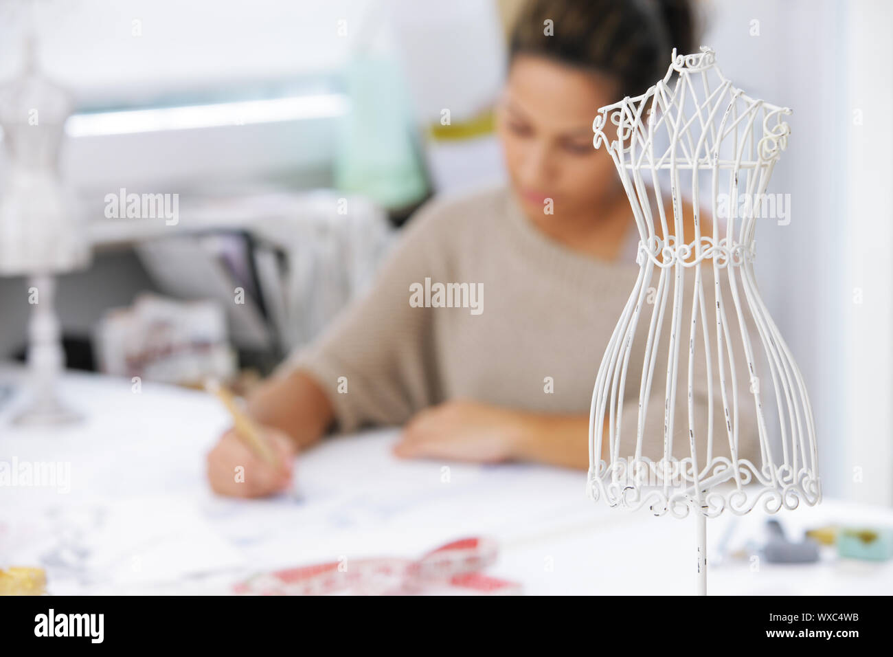 Fashion designer is drawing a fashion model Stock Photo - Alamy