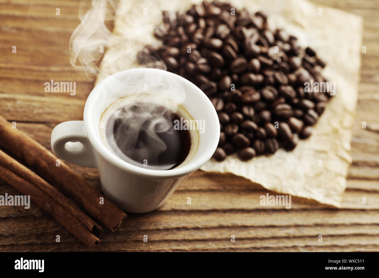 Smoking hot coffee with coffee beans Stock Photo - Alamy