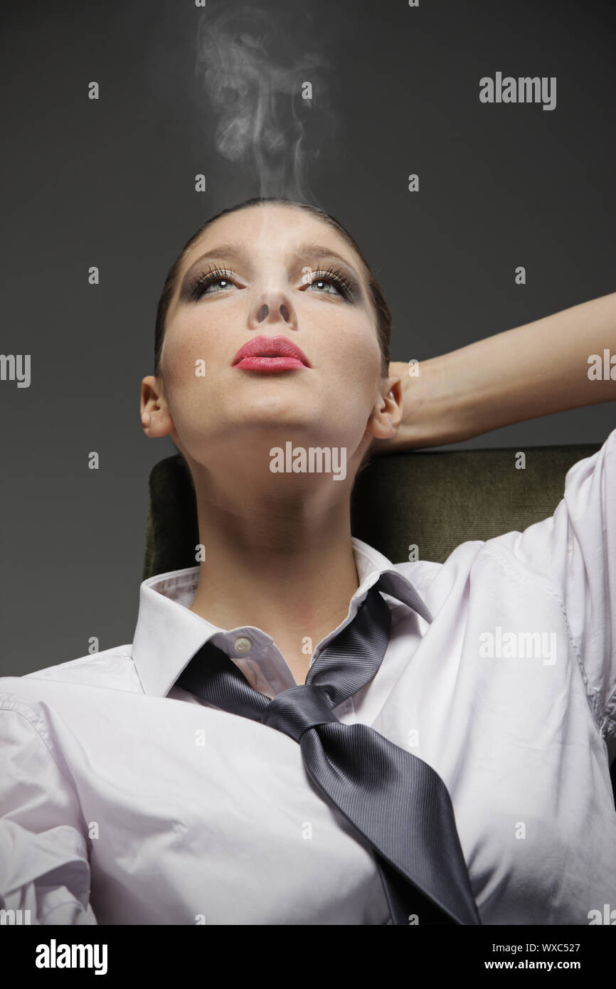 Sensual woman smoking a cigarette, fashion model Stock Photo - Alamy