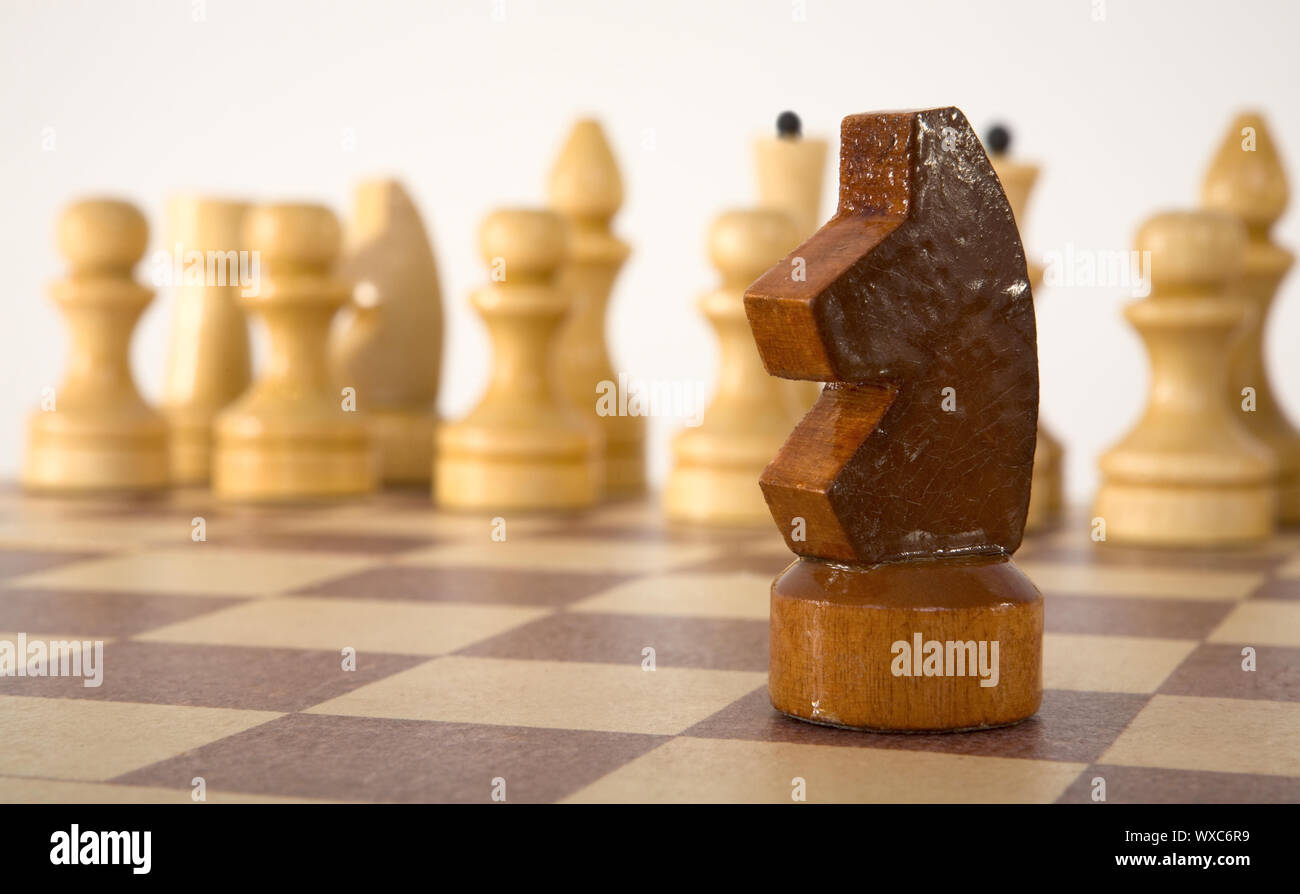 Brown wooden chess knight on a white background Stock Photo - Alamy