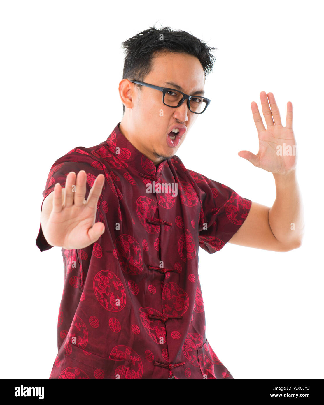Southeast Asian Chinese man practicing kungfu, isolated on white ...