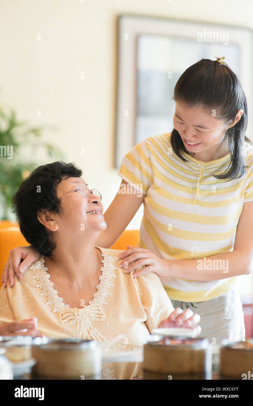 Asian Chinese family interaction inside a restaurant Stock Photo - Alamy