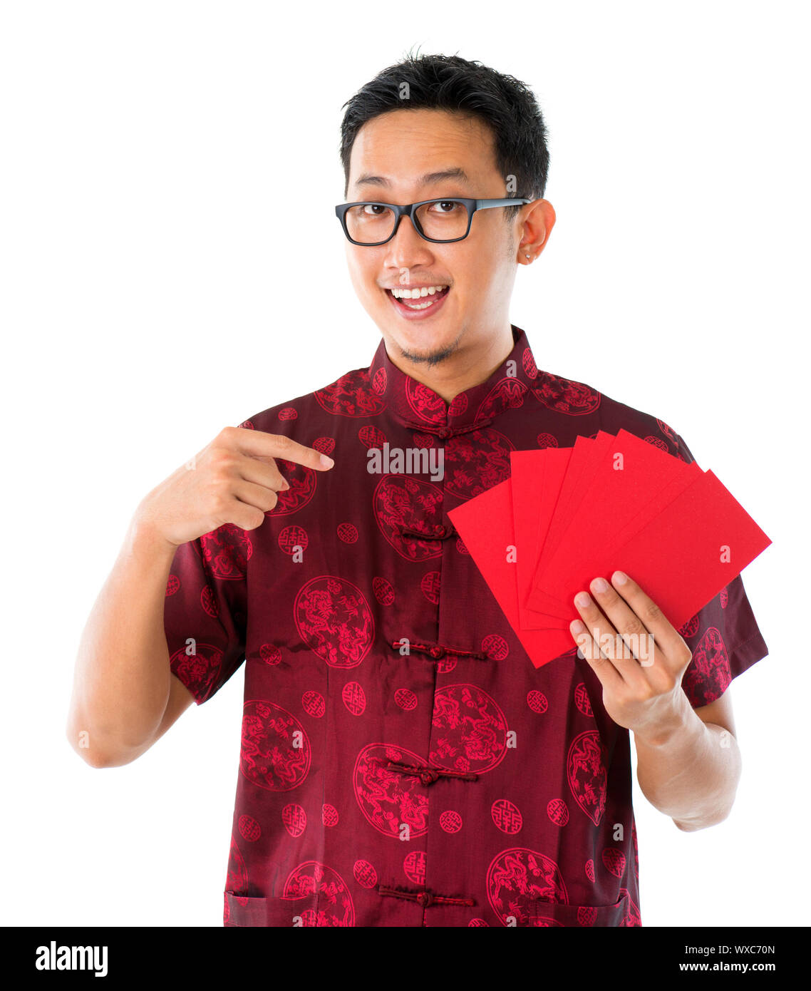 Southeast Asian Chinese male in cheongsam hands holding red packets ...