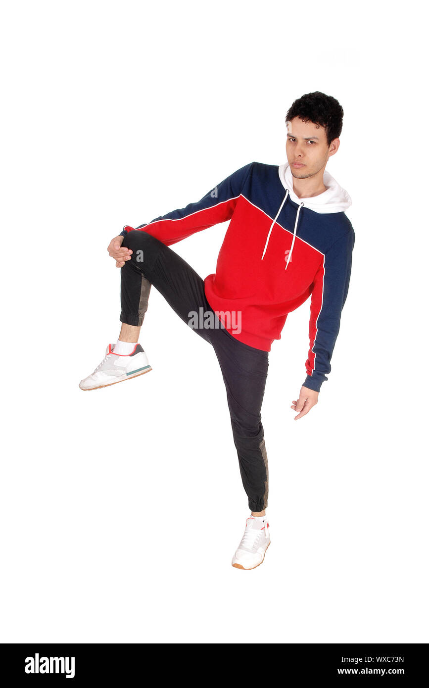 Young man stretching with one leg up Stock Photo - Alamy