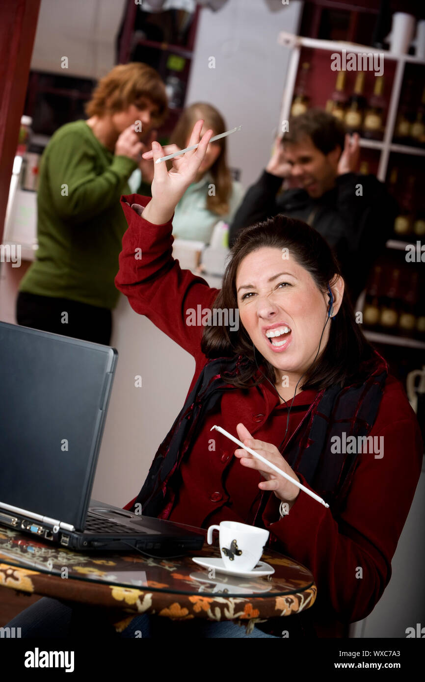 Obnoxious young woman singing loudly in a coffee house Stock Photo - Alamy