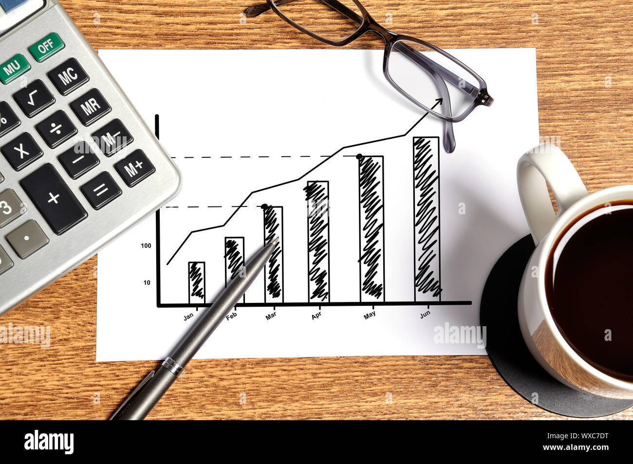 Workplace with growth chart on paper Stock Photo - Alamy