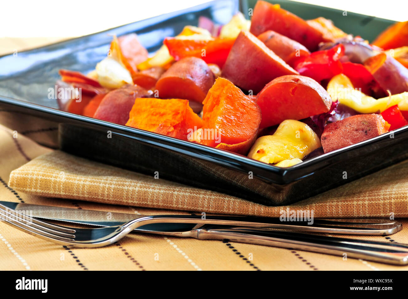 Vegetarian dish of roasted yams with cheese and peppers Stock Photo - Alamy