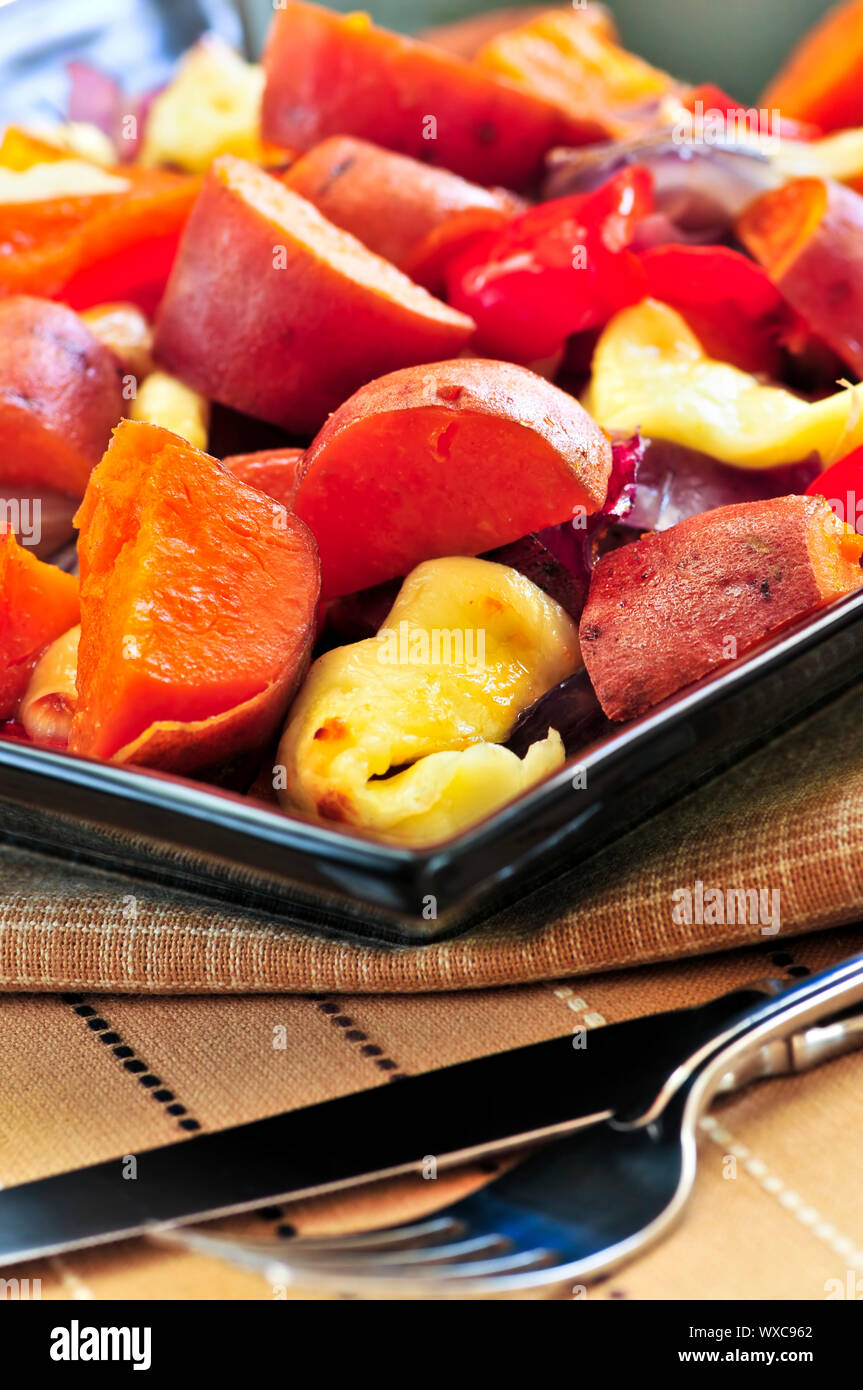 Vegetarian dish of roasted yams with cheese and peppers Stock Photo - Alamy