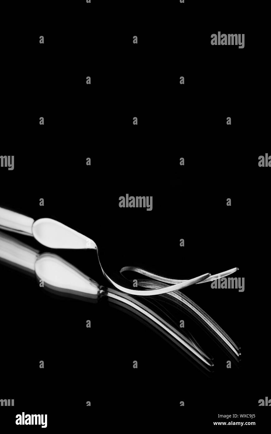 Single carving fork reflection on mirror with black background Stock ...
