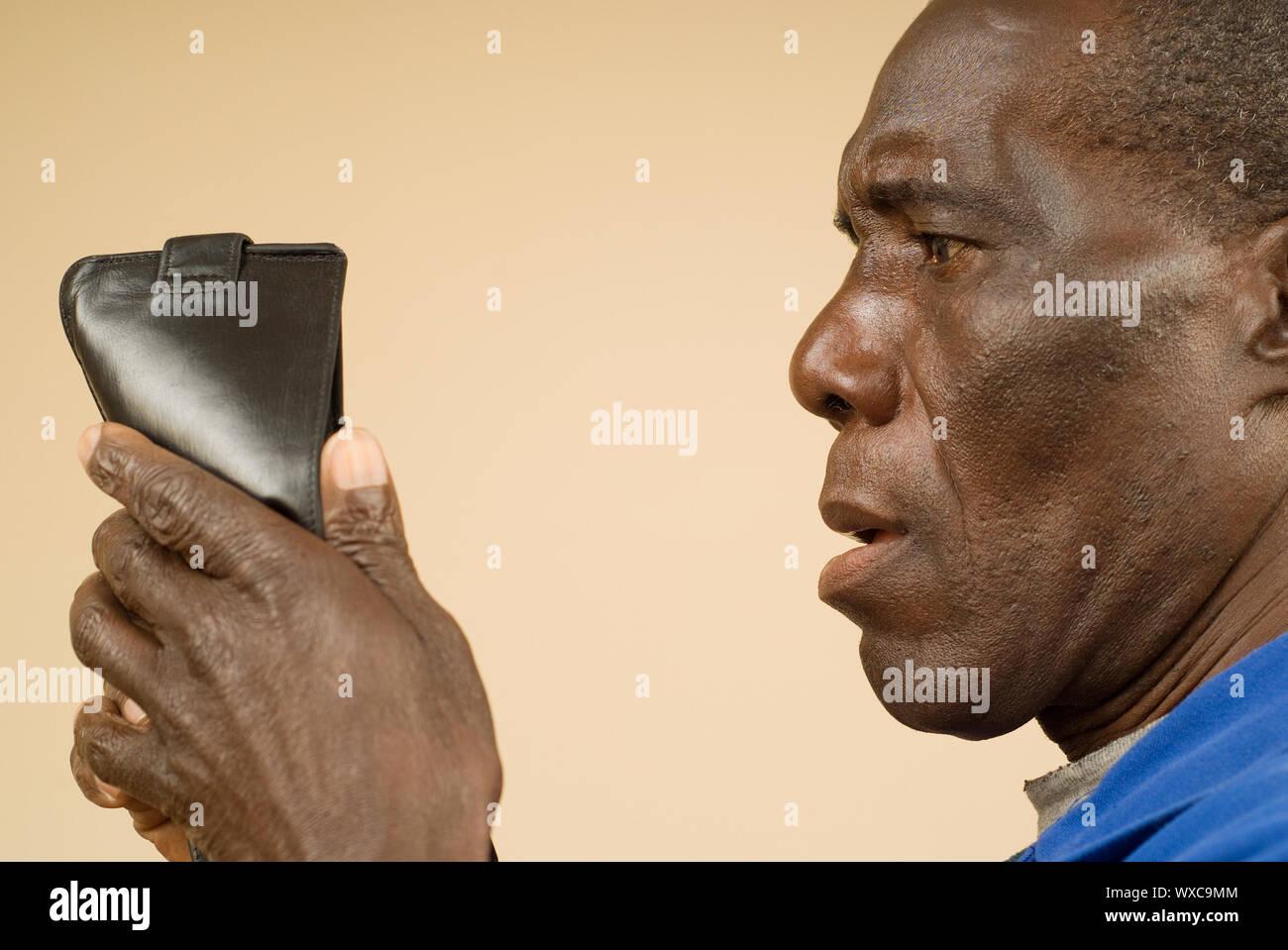 Portrait of construction worker staring at an empty wallet Stock Photo ...